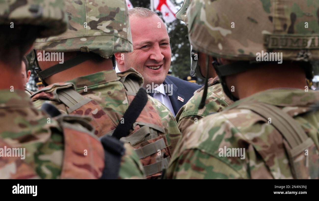 Georgian President Georgy Margvelashvili, center, looks at servicemen ...