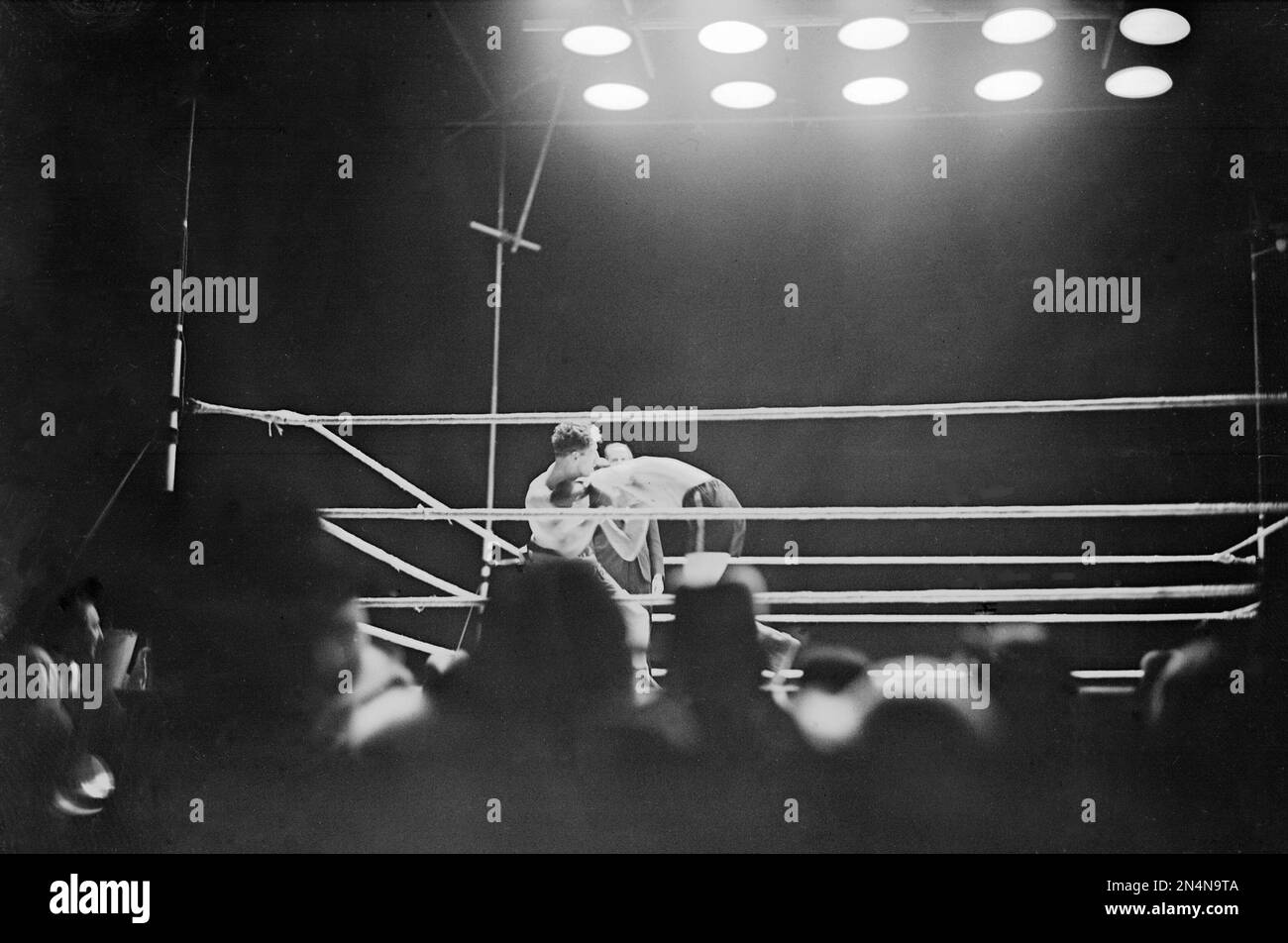 Champion Len Harvey of England, left, holds on to Jack Petersen of ...