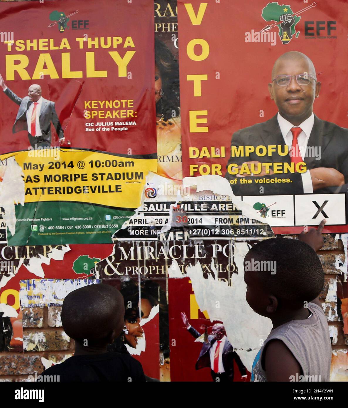 Young boys look at the Economic Freedom Fighters (EFF) election posters ...