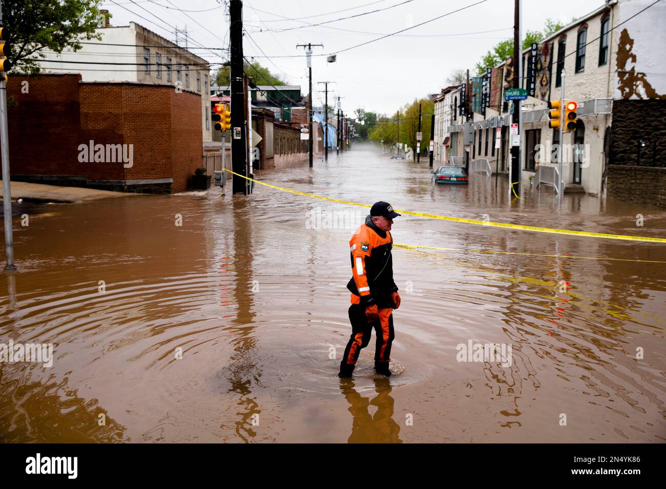 Marine unit police officer Robert Jonah walks through flood waters from ...