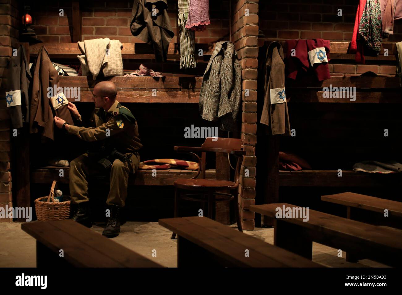 An Israeli officer looks at a jacket with a Star of David arm band at a ...