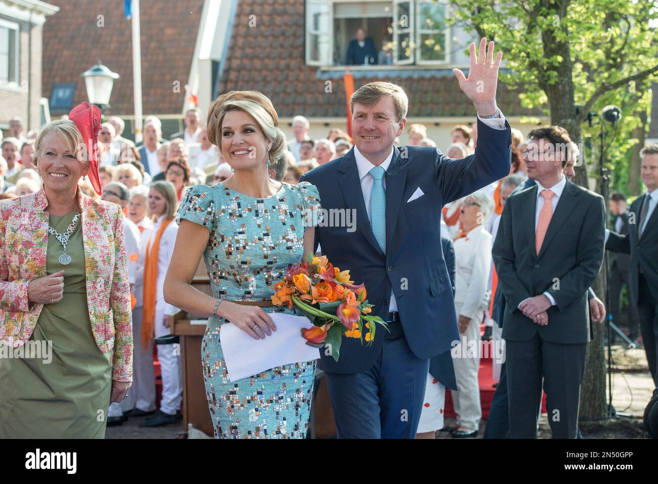 Netherlands' King Willem Alexander, right, waves to well wishers as ...