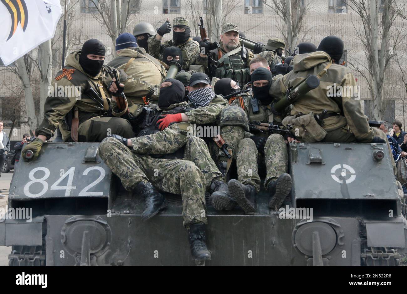 A combat vehicle with pro-Russian gunman on top runs through downtown ...
