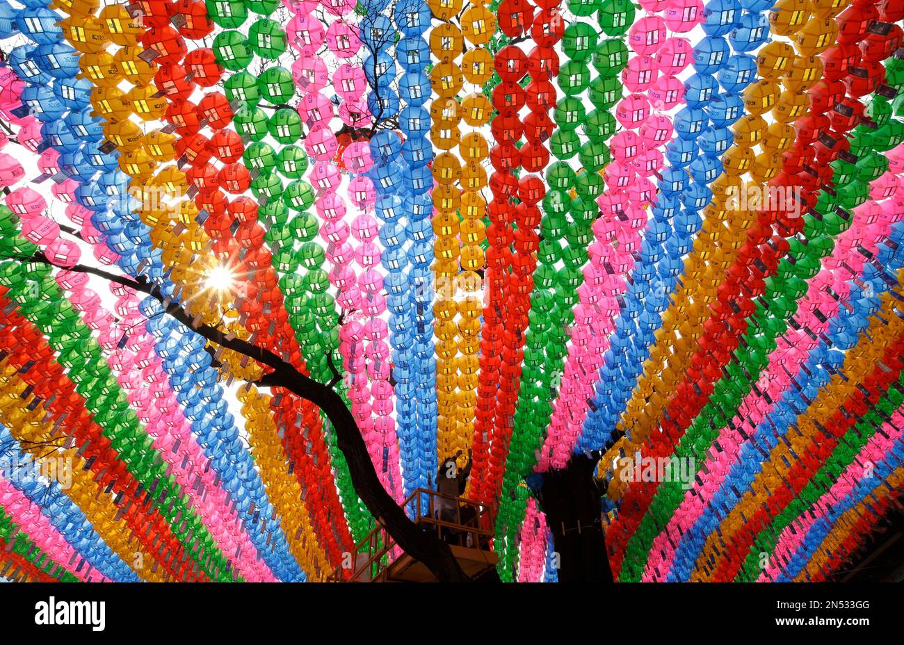 A worker attaches the name tag of a Buddhist who made donation to a ...