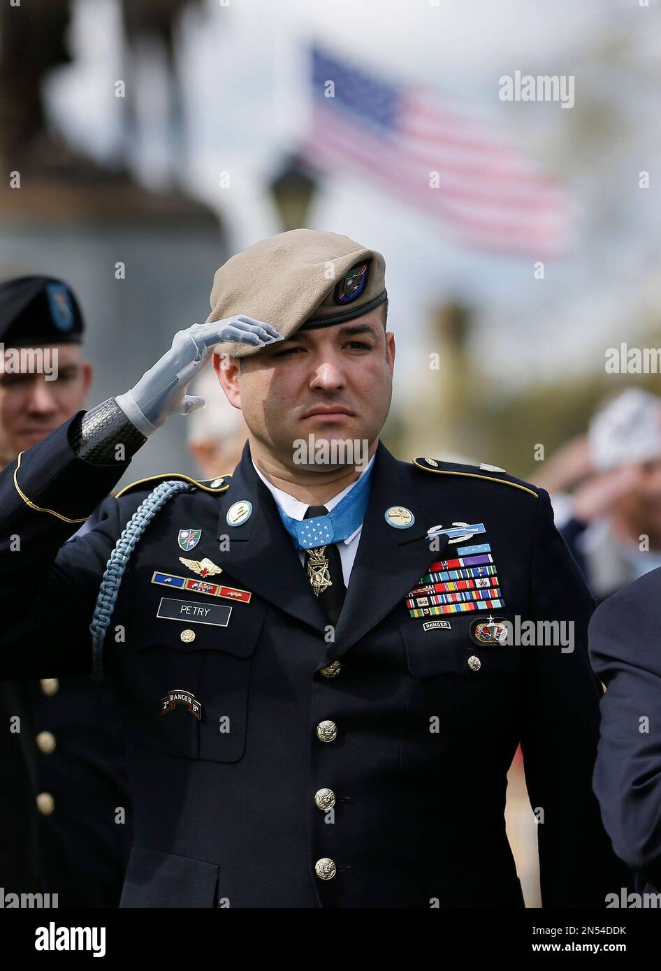 Medal of Honor recipient Sgt. 1st Class Leroy Petry stands and salutes ...