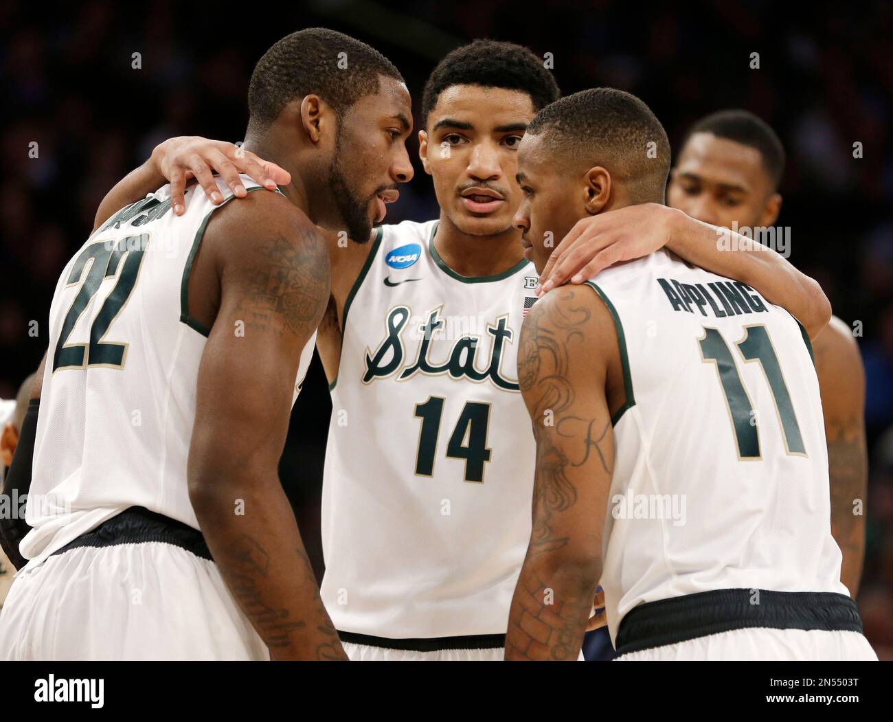 Michigan State's Branden Dawson, left, huddles with teammates Gary ...