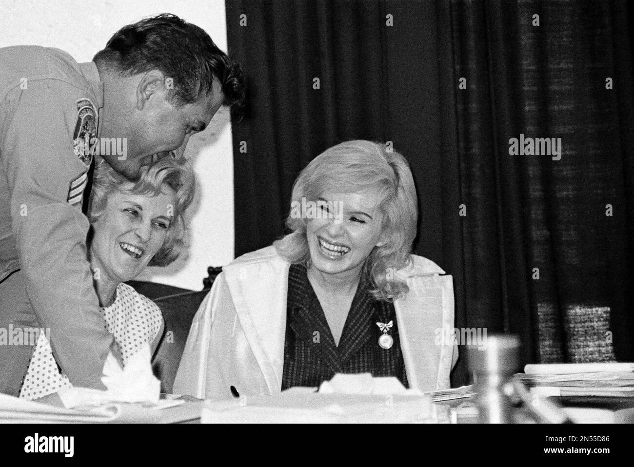 Candace Mossler, right, is all smiles as an unidentified Metro Sgt ...