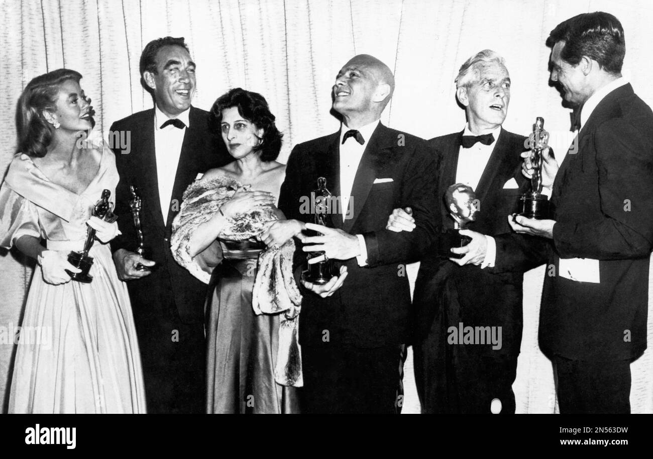 Yul Bryner, third right, holds the Oscar he won for best actor at the ...