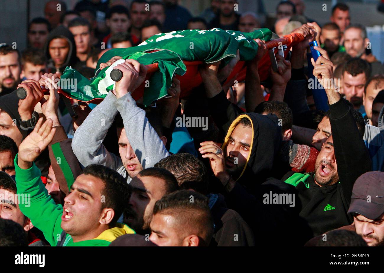 Palestinians carry the body of Hamza Abu el-Heija, who was killed in a ...