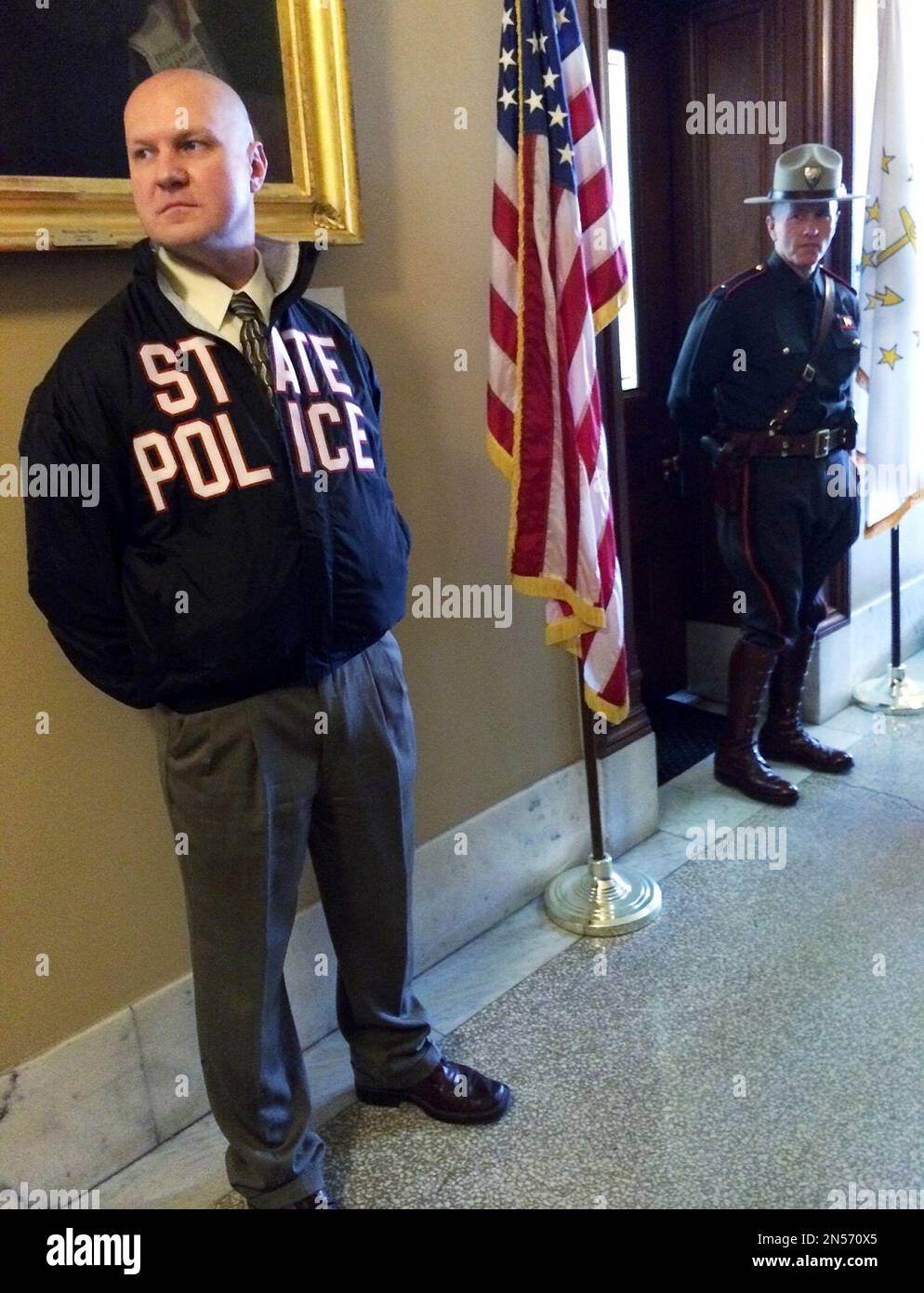 Rhode Island state police officers stand outside the office of House ...