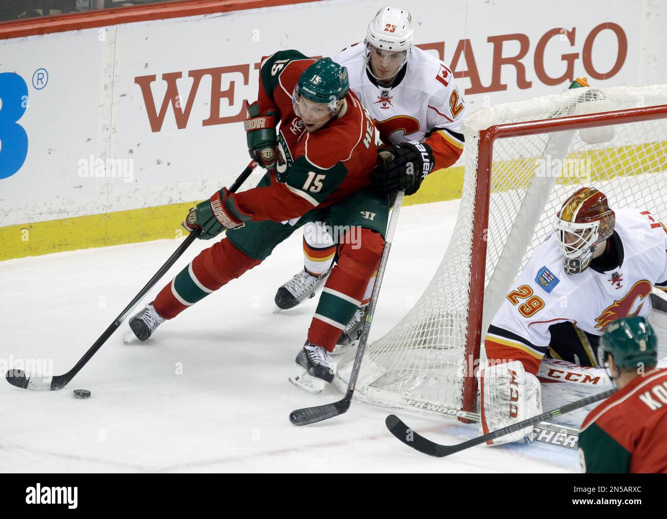 Minnesota Wild's Dany Heatley, left, cuts the corner as he is pursued ...