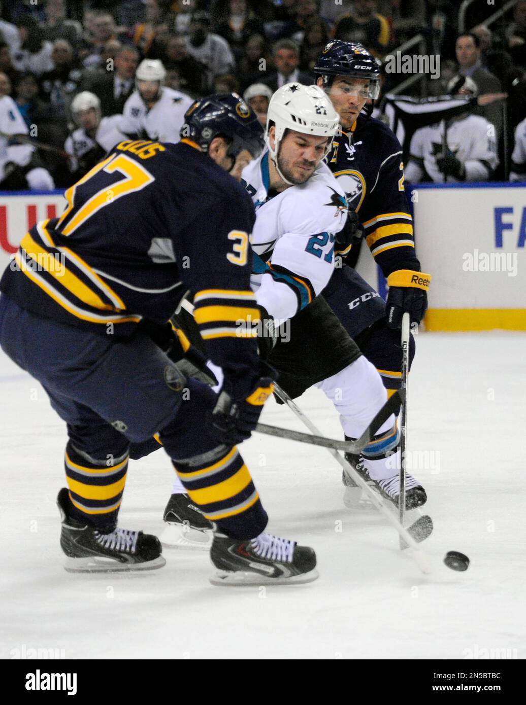 San Jose Sharks' Scott Hannan (27) skates between Buffalo Sabres' Matt ...