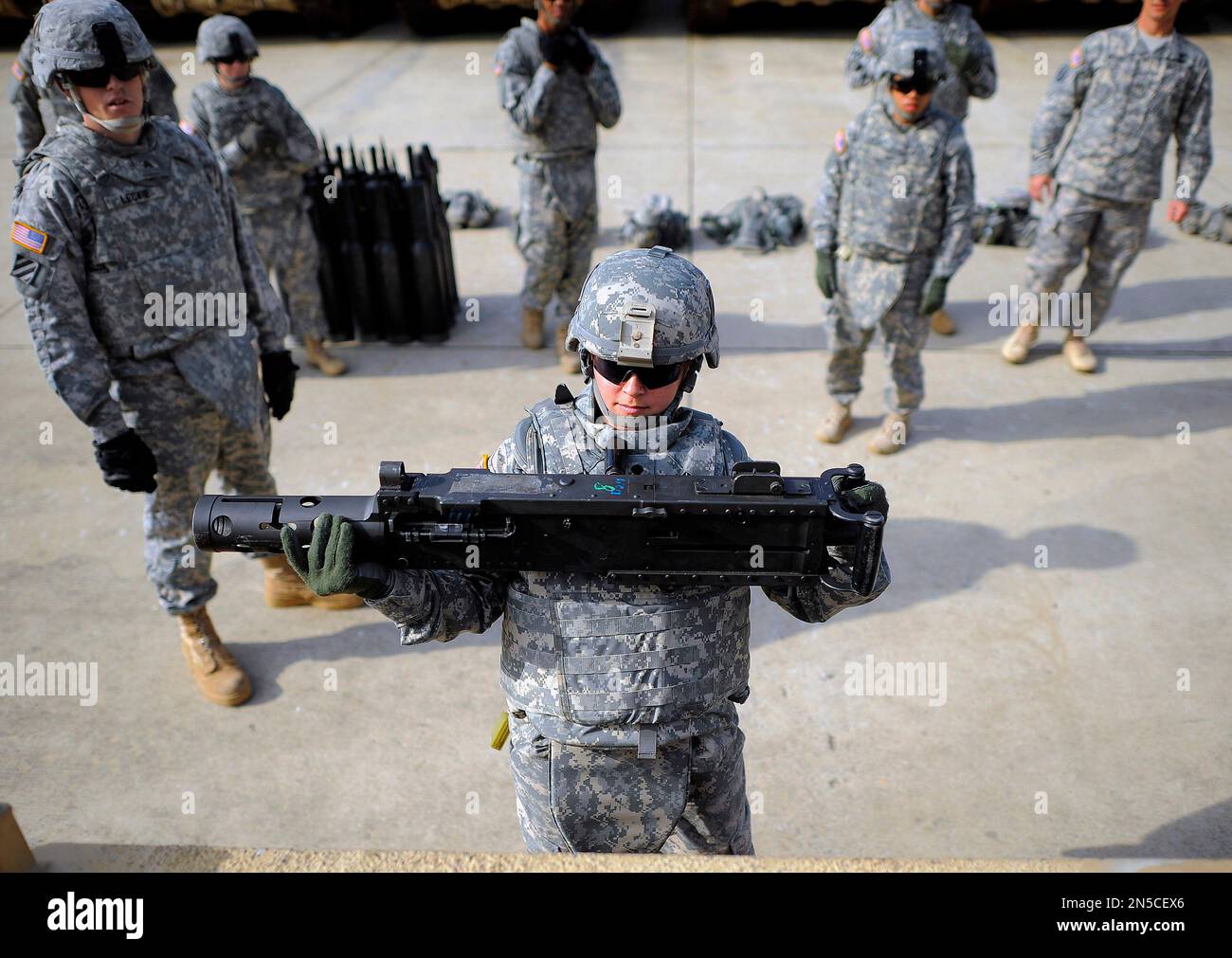 U.S. Army SPC Sheena Mature hoists a 44-pound section of a 50 caliber ...