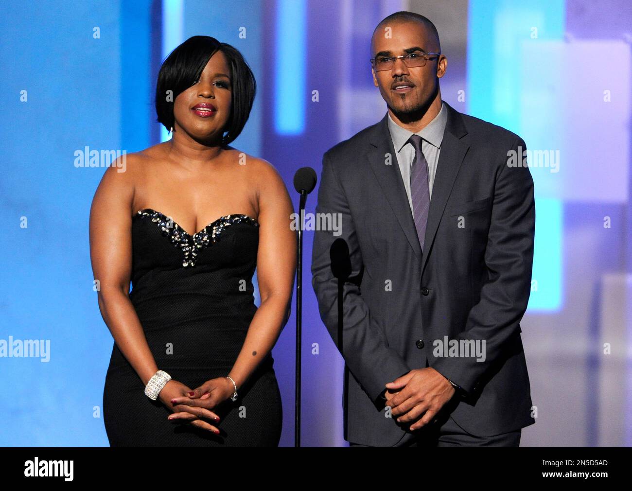 NAACP chairman Roslyn M. Brock, left, and Shemar Moore speak on stage ...