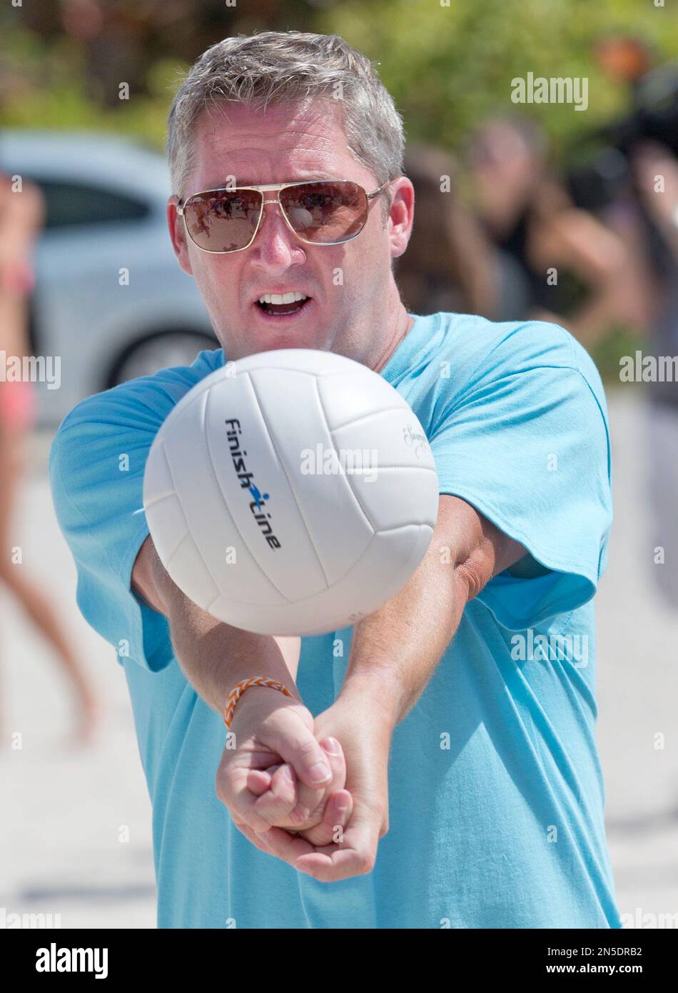Tim Love warms up before a match as a dozen Sports Illustrated swimsuit ...