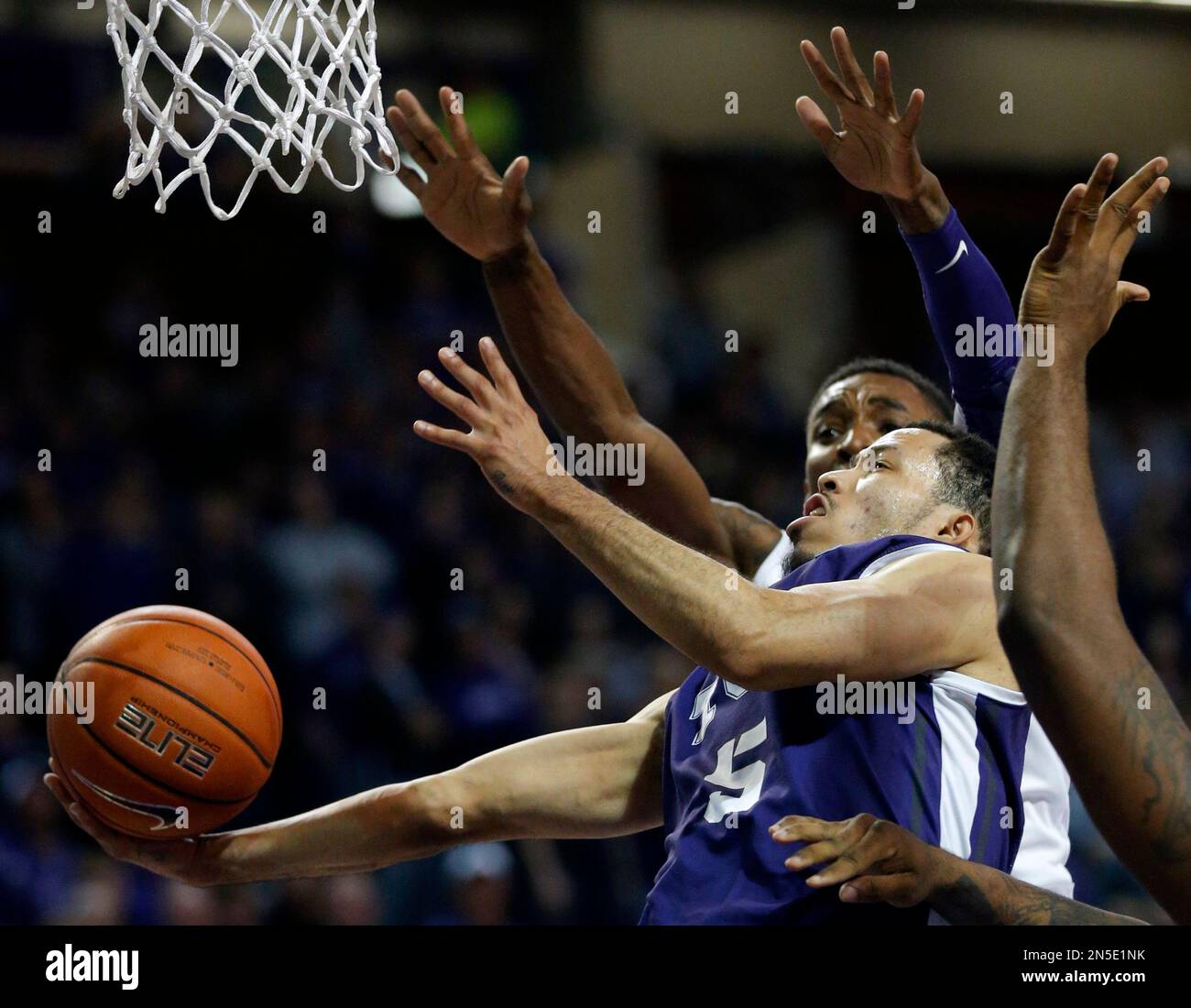 TCU guard Kyan Anderson (5) shoots while covered by Kansas State guard ...
