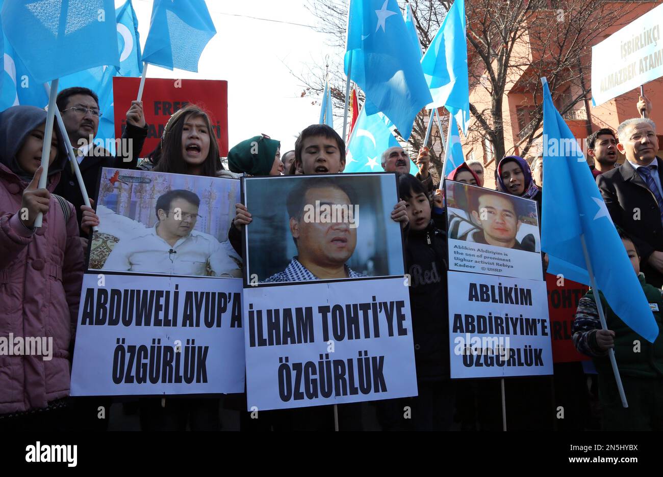Uighur children living in Turkey hold photos of people imprisoned in ...