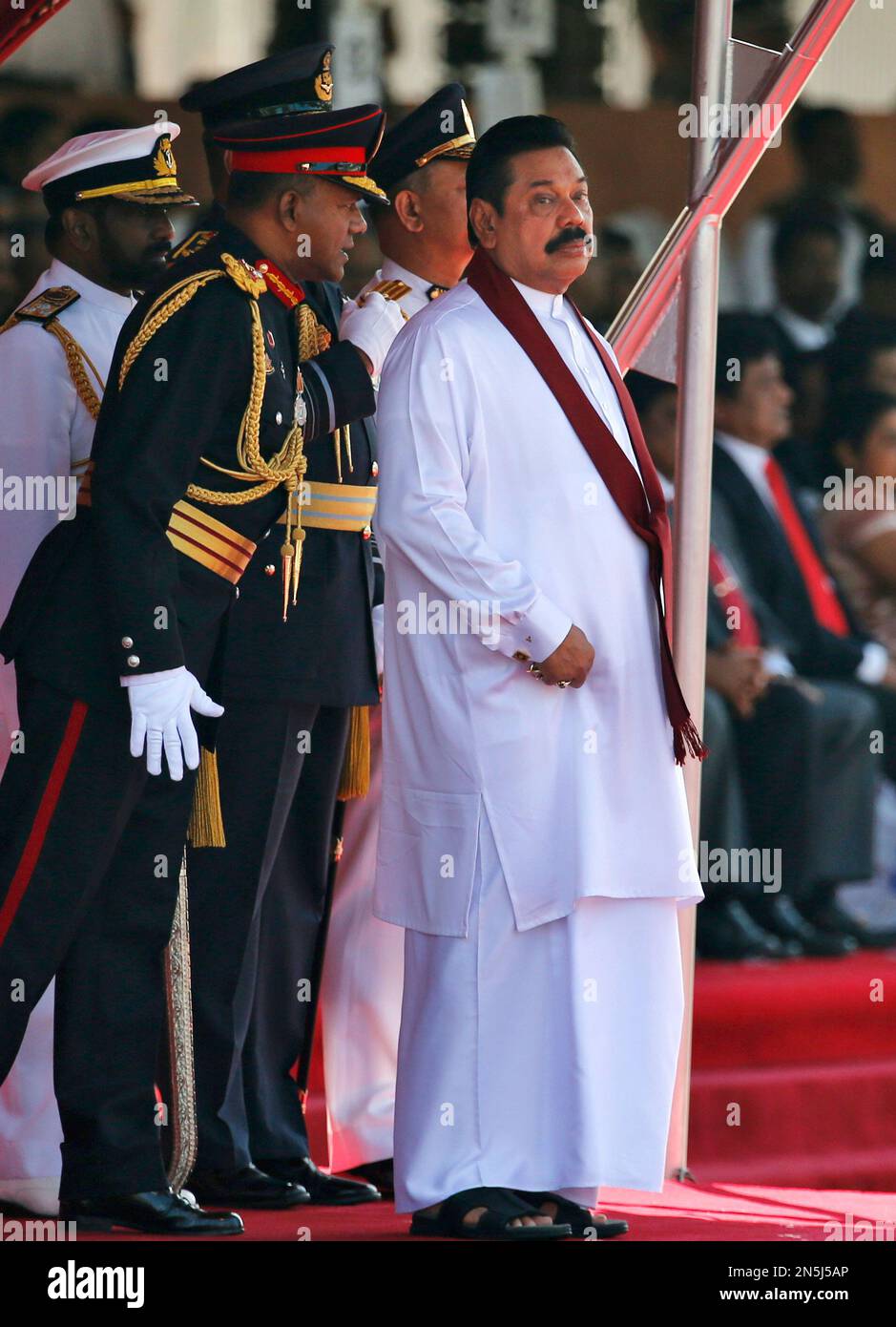 Sri Lanka's President Mahinda Rajapaksa, right, listens to Army ...