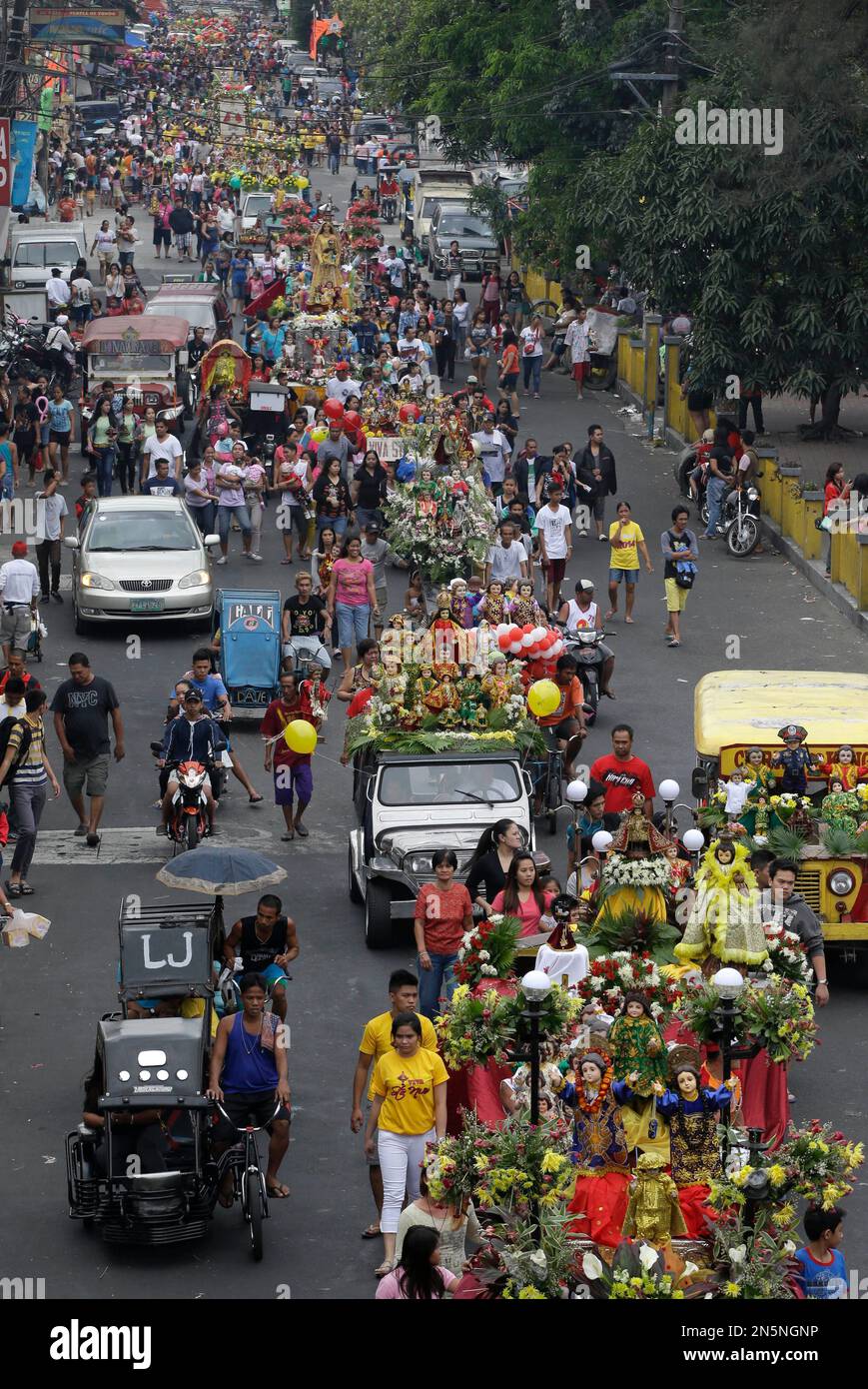 Images of the Infant Jesus known as Sto. Nino are mounted on vehicles ...