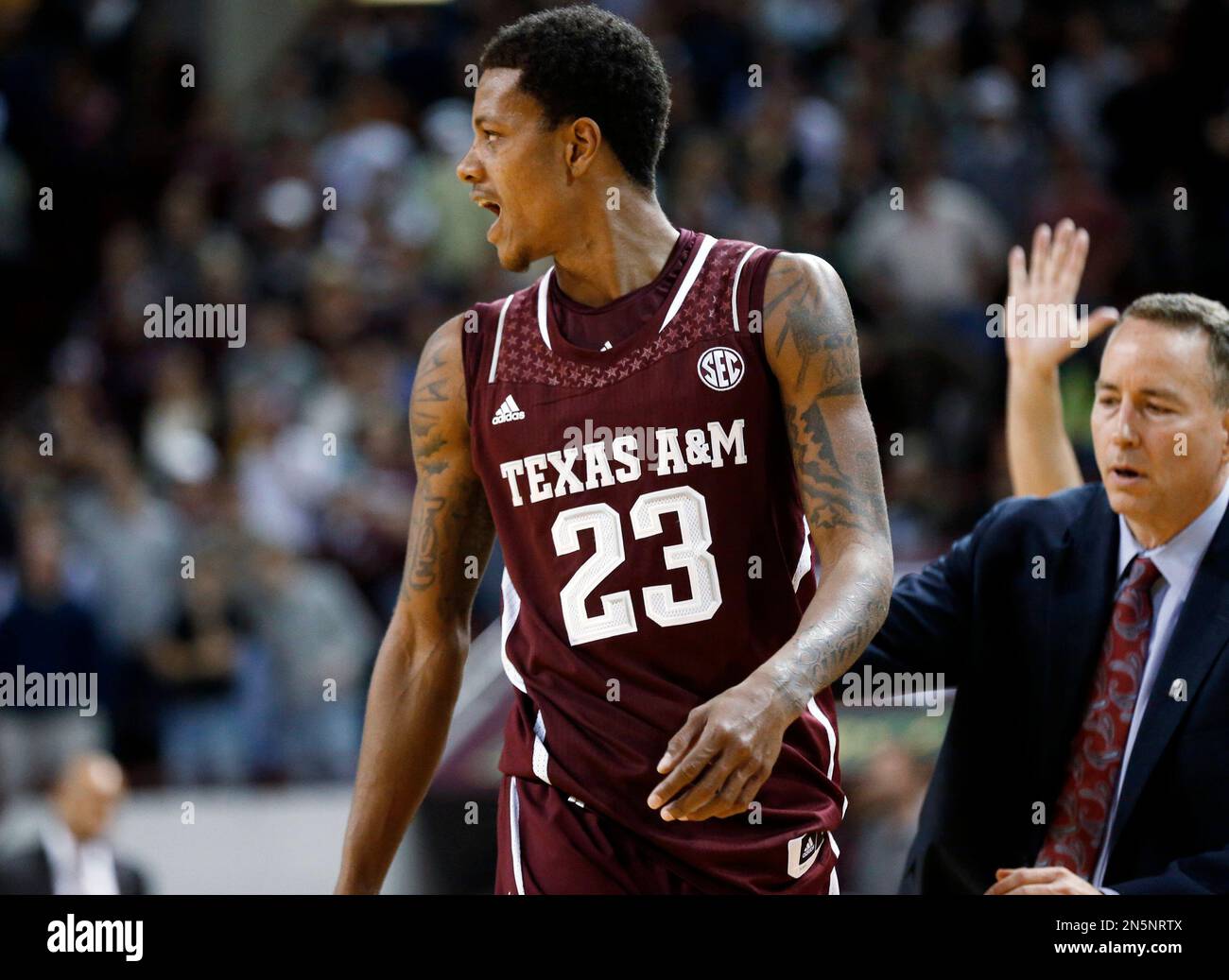 Texas A&M guard Jamal Jones (23) makes a point as coach Billy Kennedy ...