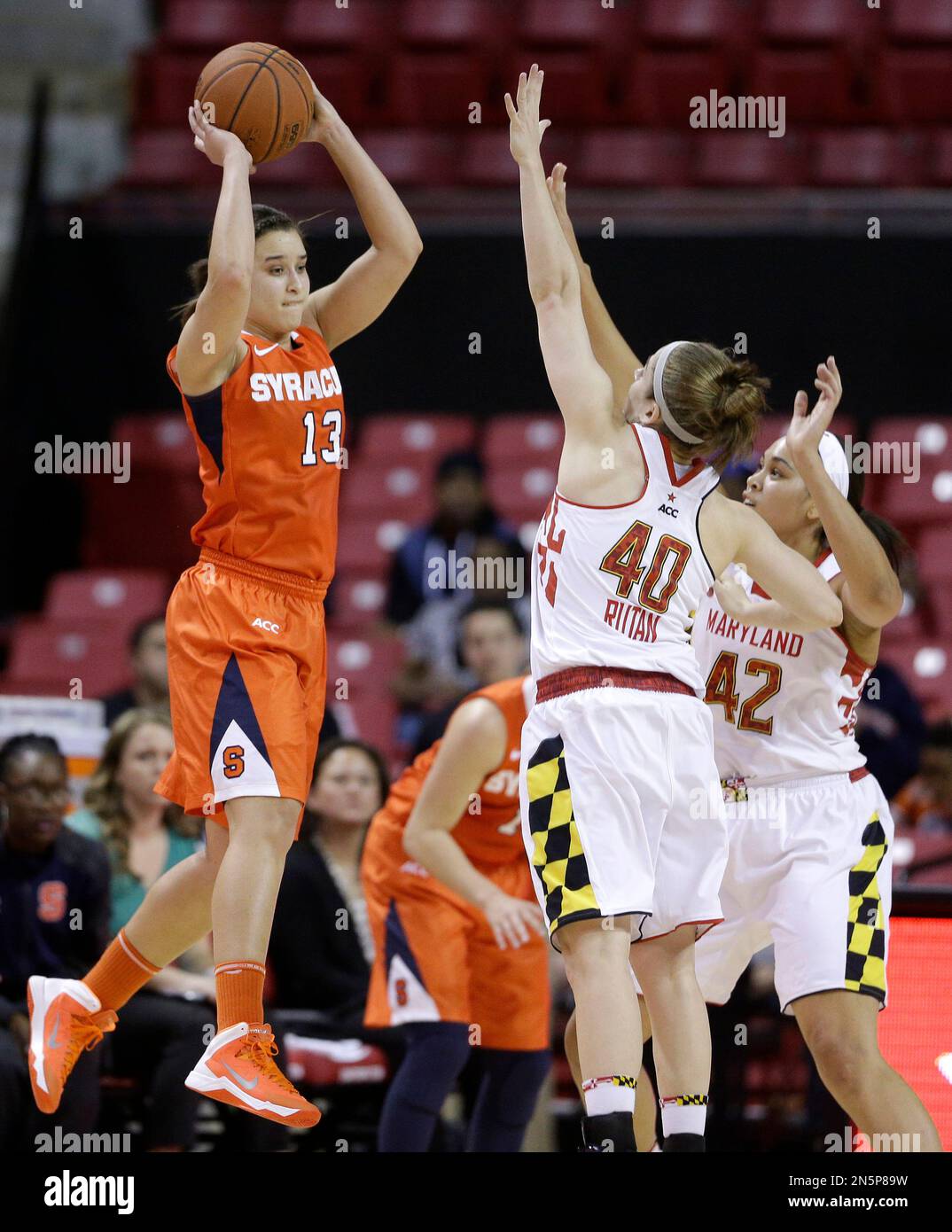 Syracuse guard Brianna Butler, left, attempts to pass to a teammate as ...