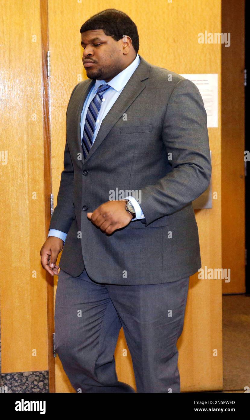 Former Dallas Cowboys' Josh Brent walks in the court hallway during a ...