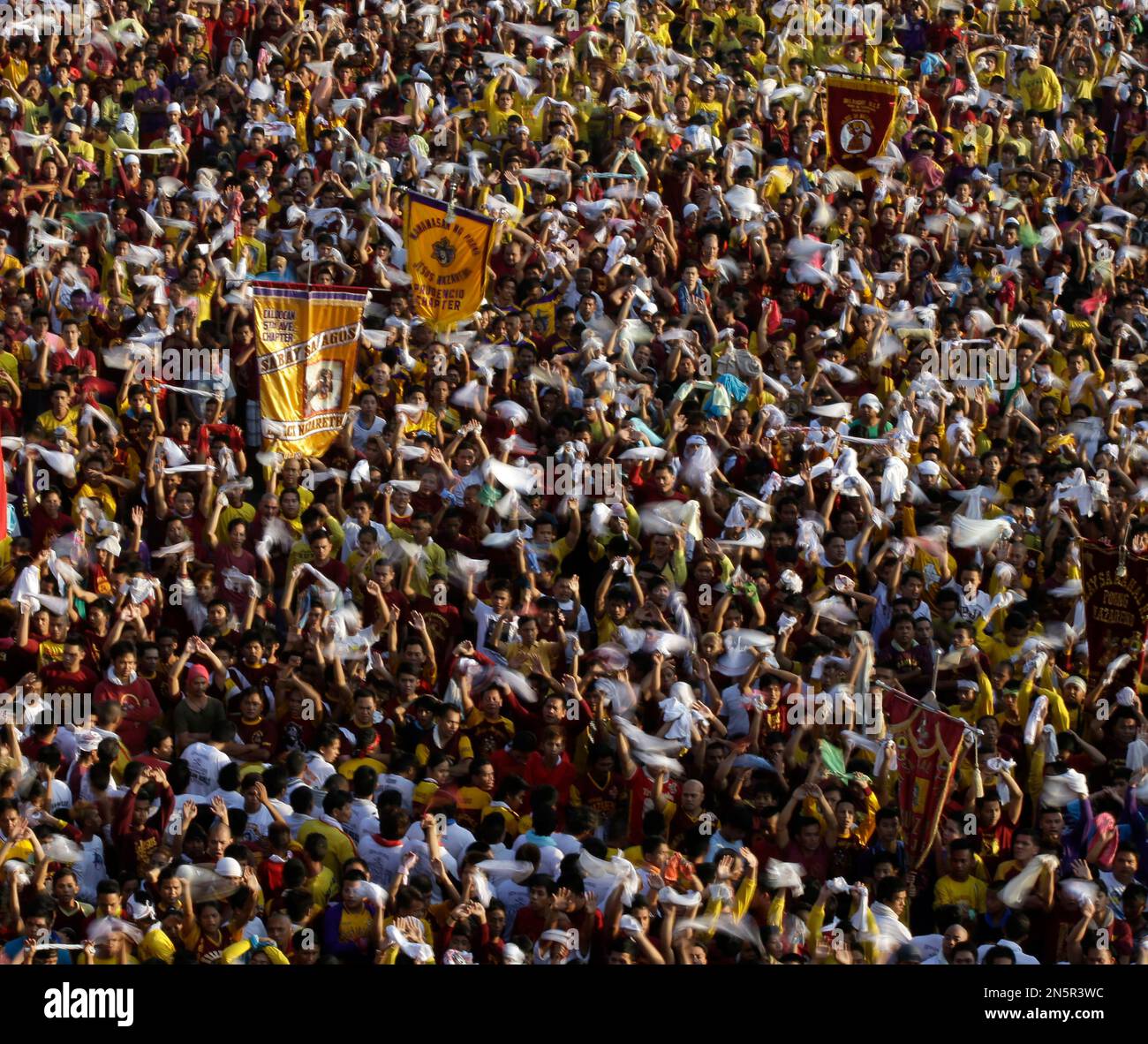 Filipino Catholic devotees wave their white handkerchiefs during a mass ...