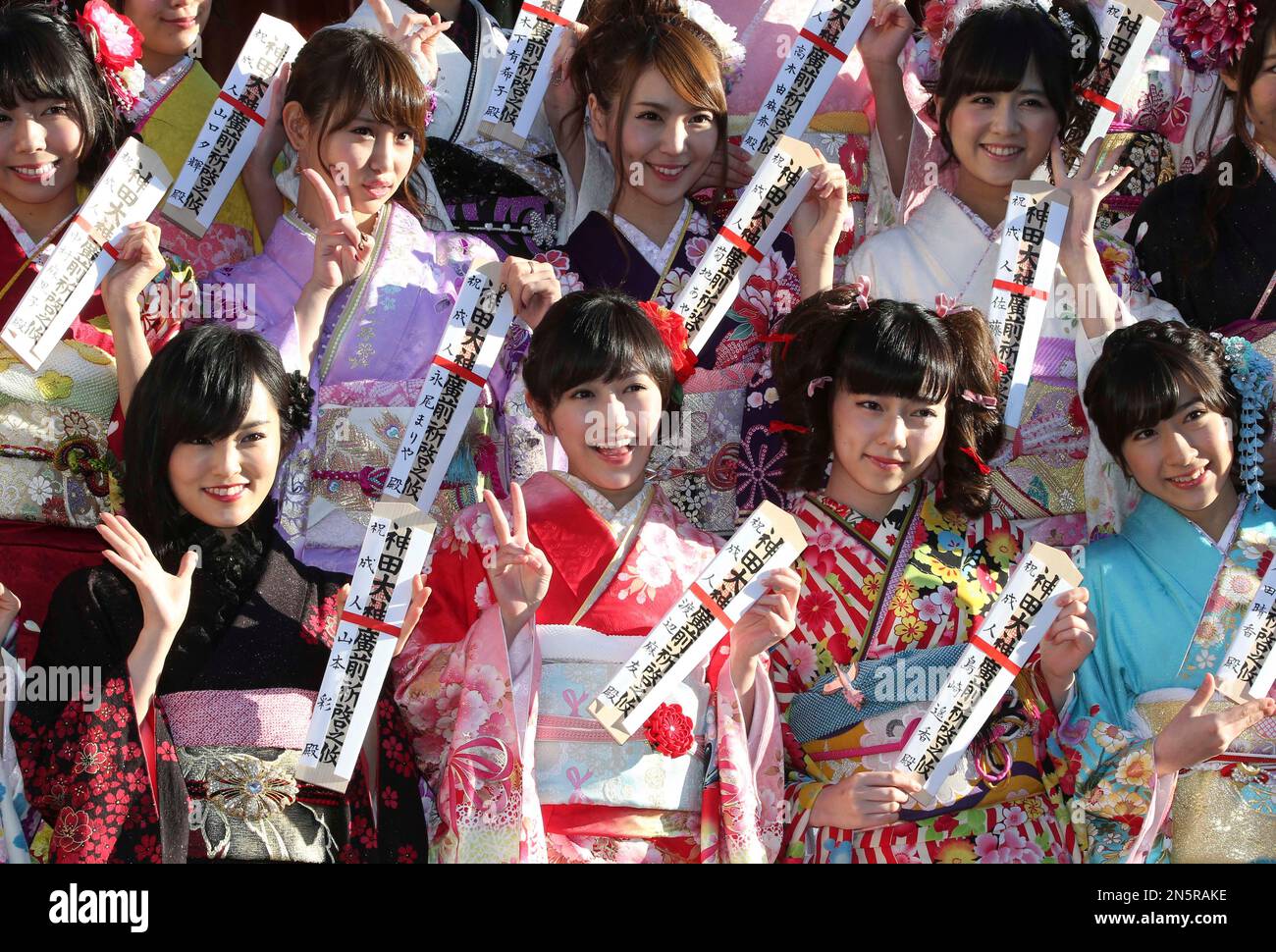 Kimono-clad members of Japan's most popular girl group AKB 48, Mayu Watanabe, front row second ...