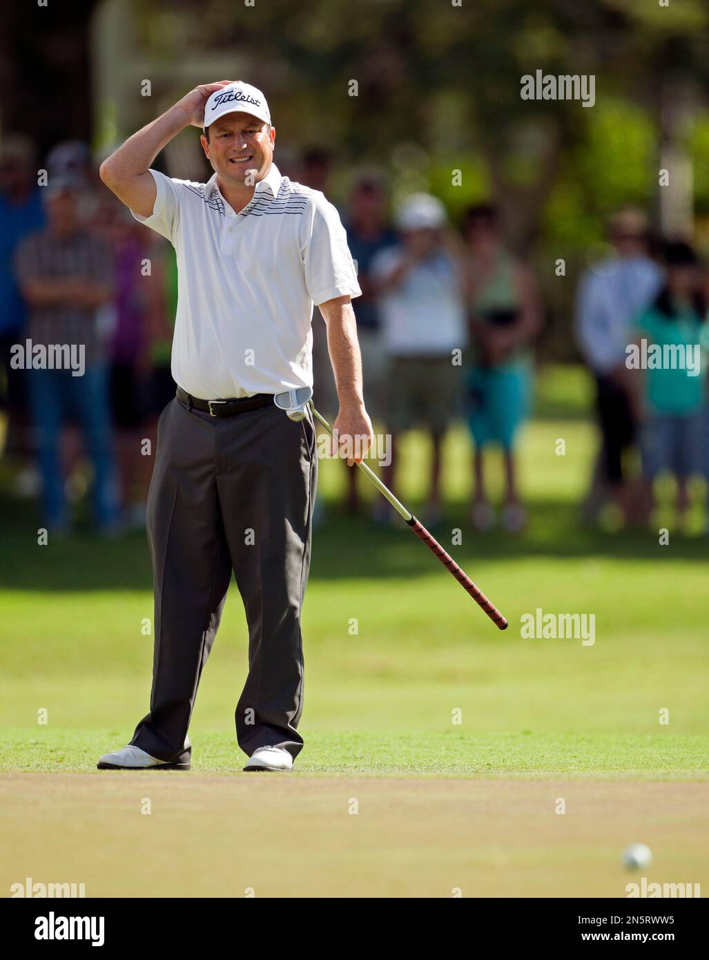 Tim Clark, of South Africa, reacts to his putt on the third green ...