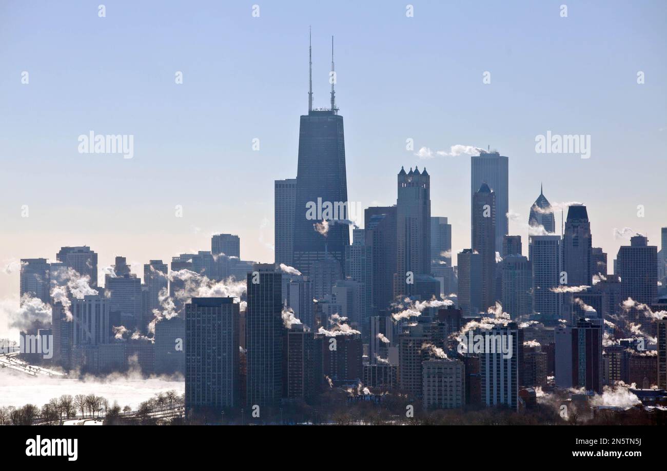 Steam rises from the tops of buildings in the Chicago skyline Monday ...