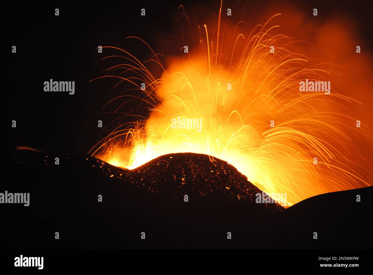 Lava spews from the South East Crater of Mt. Etna during an eruption ...