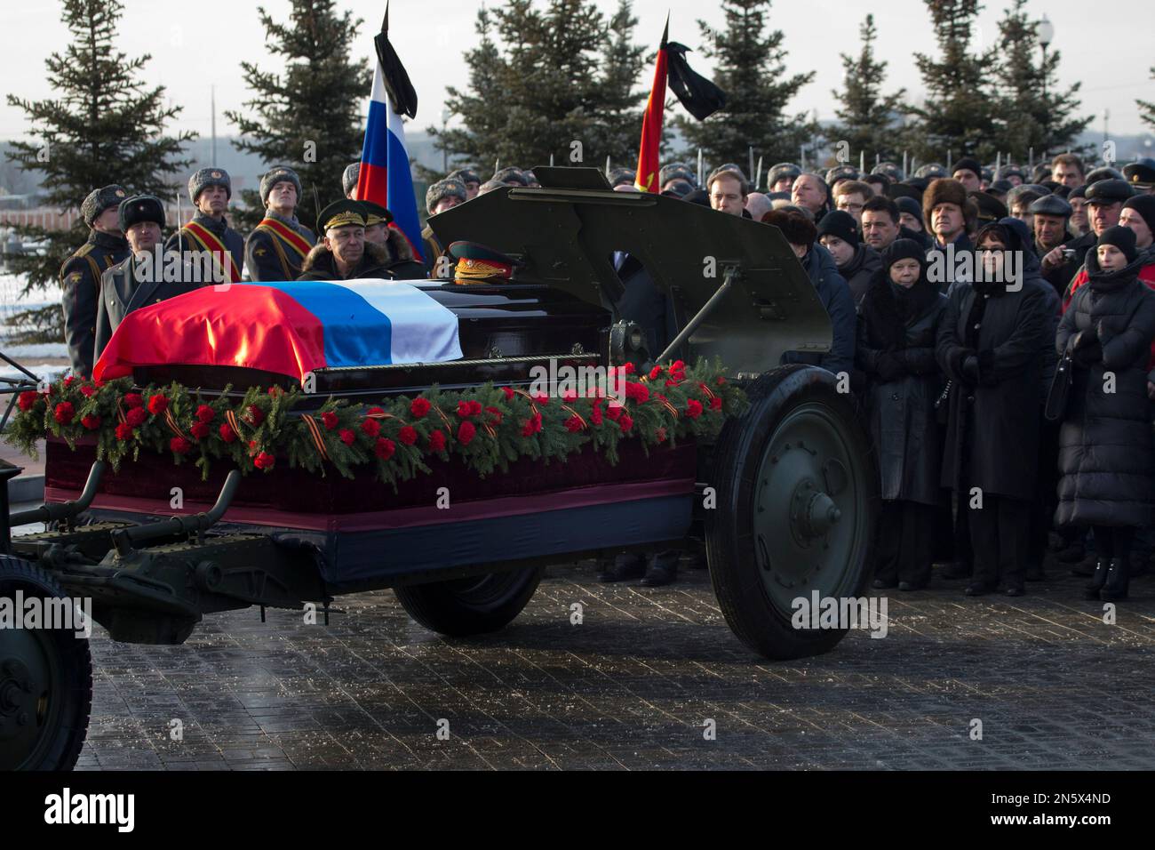 The honor guard's armored personnel carrier pulls a coffin bearing the ...