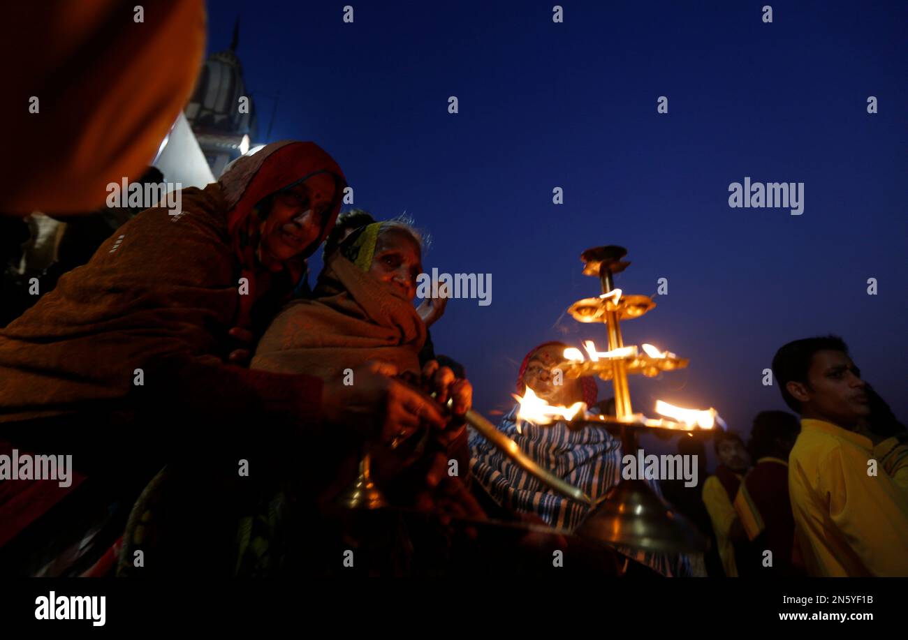 Indian Hindu devotees perform "Aarti" a ritual involving rotating a ...