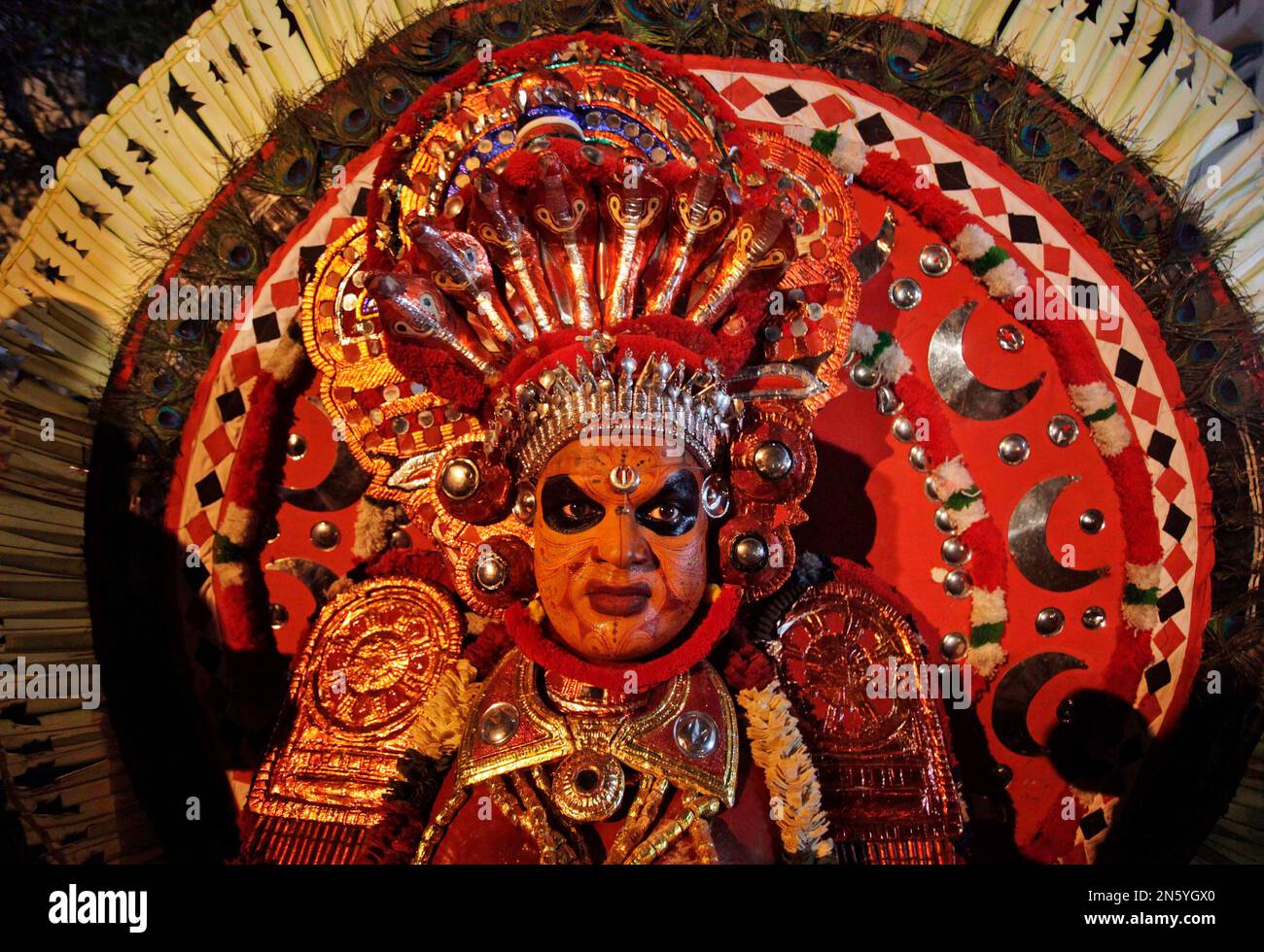 In this Sunday, Dec. 15, 2013 photo, an Indian performer of Theyyam ...