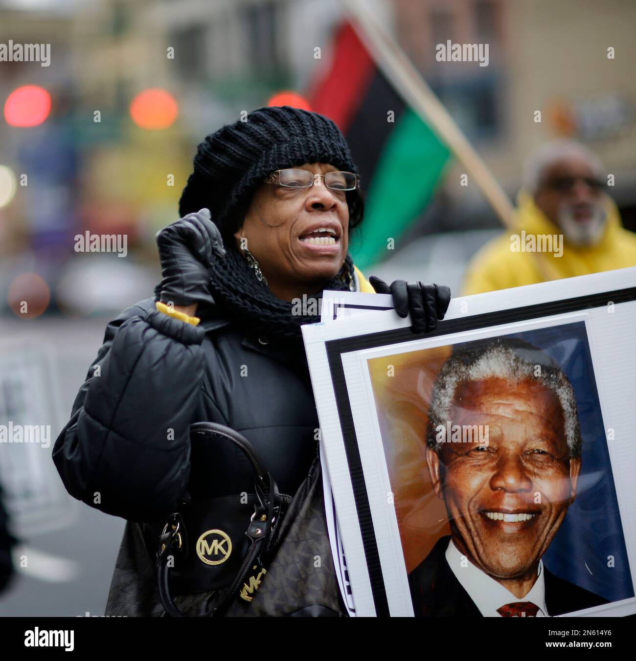 Barbara King, of Newark, holds a large photograph of Nelson Mandela, as ...