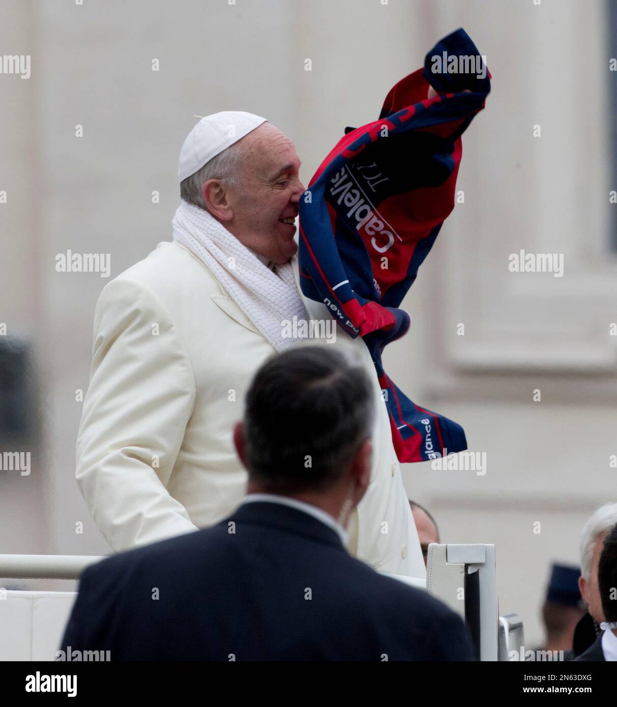 Pope Francis grabs a shirt thrown to him by faithful as he leaves at ...