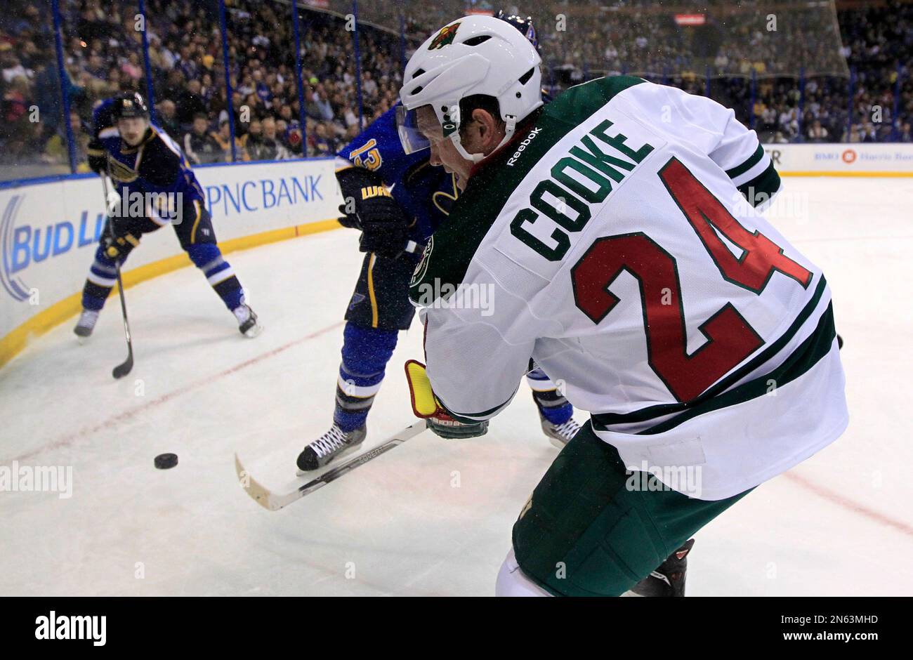 Minnesota Wild's Matt Cooke (24) passes the puck around St. Louis Blues ...