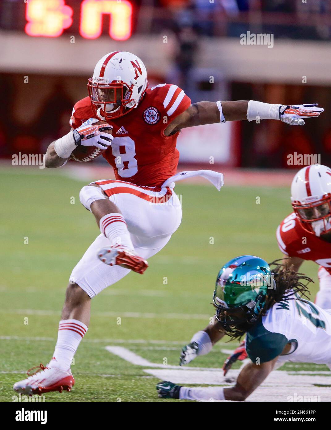 Nebraska running back Ameer Abdullah (8) vaults over Michigan ...