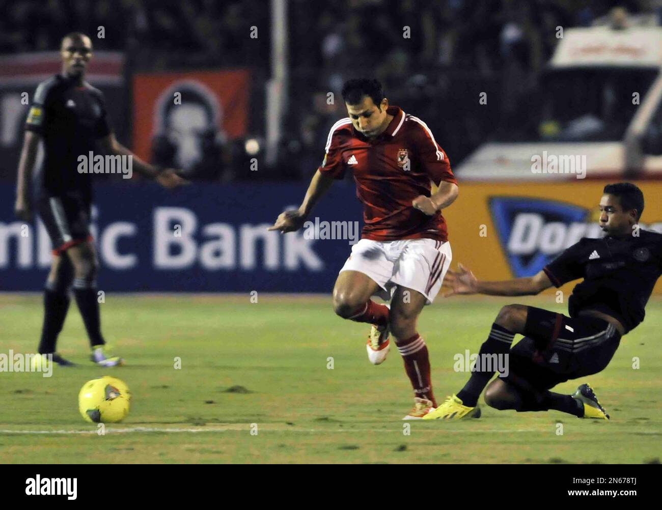 Egyptian Al Ahly club player Sayed Moawad, center, fights for the ball ...