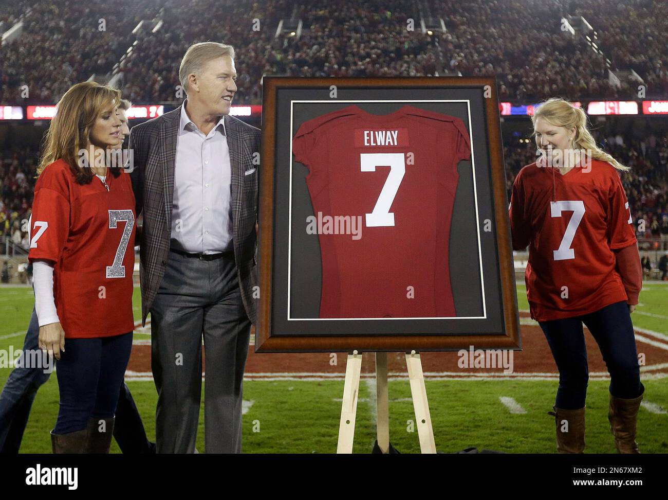 Former Stanford quarterback John Elway, second from left, stands next ...
