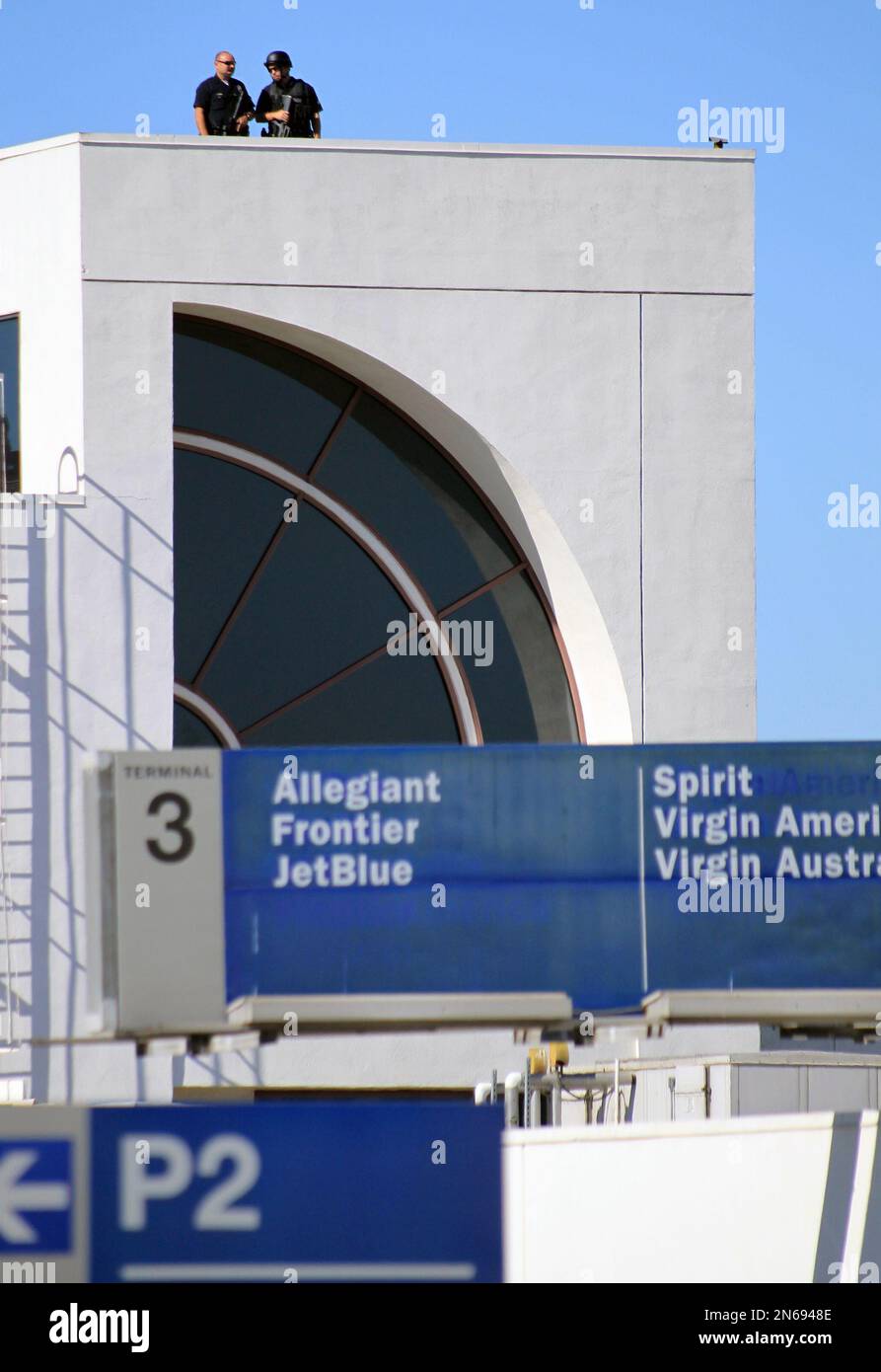 Police officers stand guard atop Terminal 3 at the Los Angeles ...