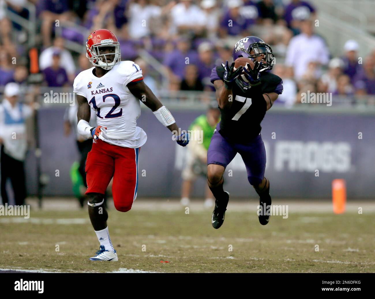 Kansas cornerback Dexter McDonald (12) watches as TCU wide receiver Kolby Listenbee (7) is ...