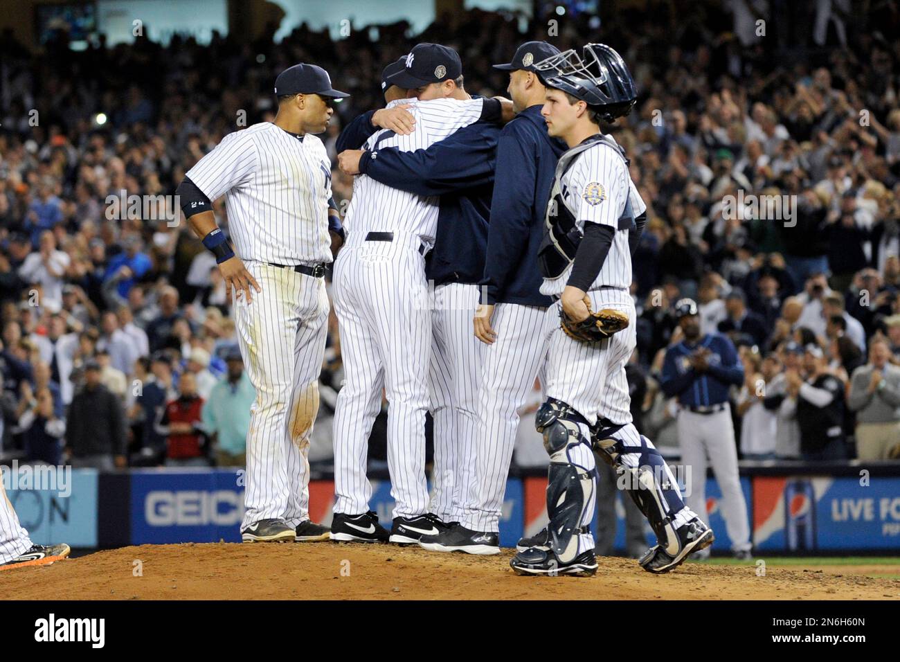 New York Yankees' Mariano Rivera hugs Andy Pettitte as Derek Jeter and ...
