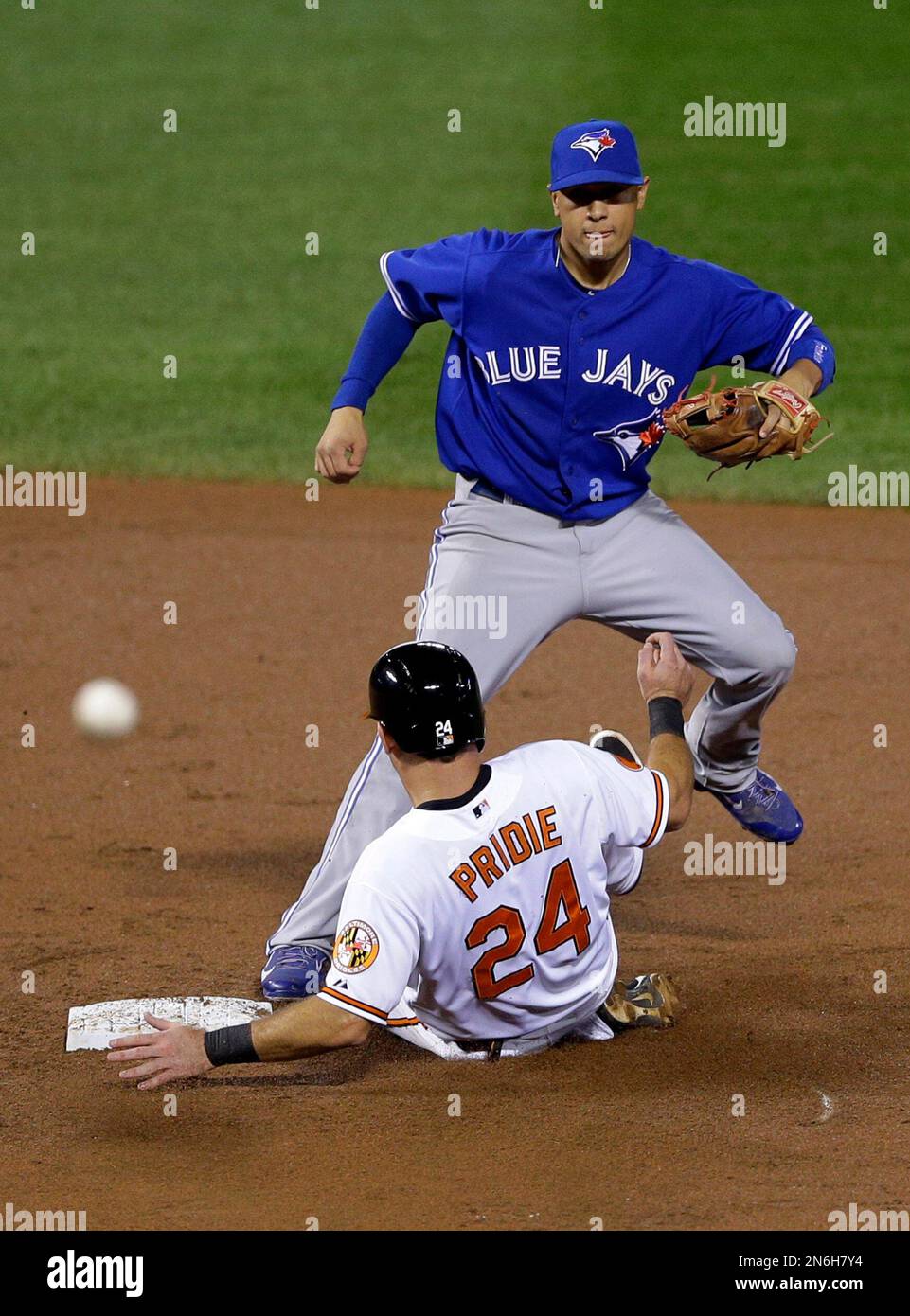 Toronto Blue Jays second baseman Ryan Goins, top, leaps out of the way ...