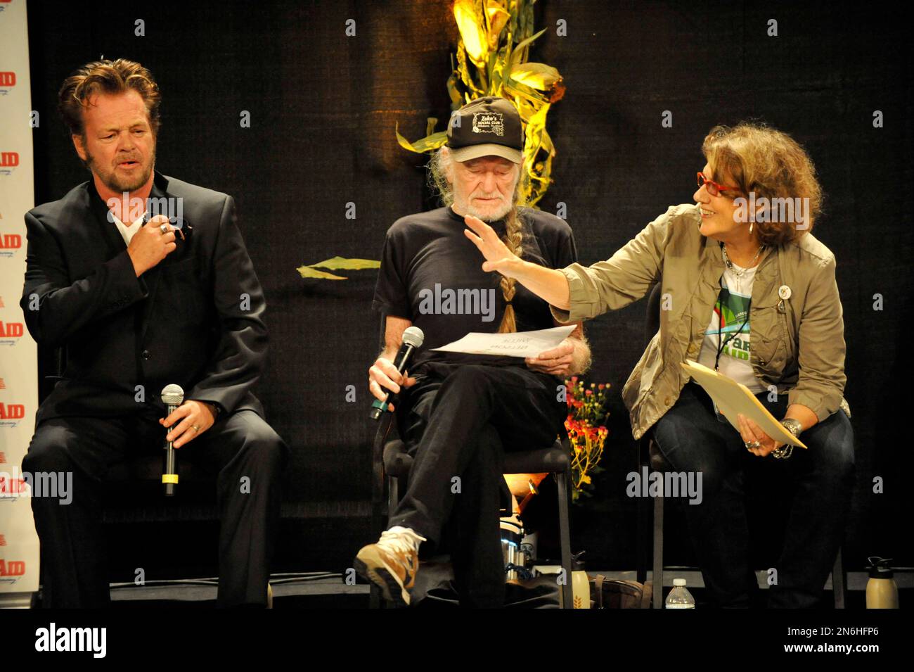 Musicians John Mellencamp, left, Willie Nelson ,center, talk with Farm ...