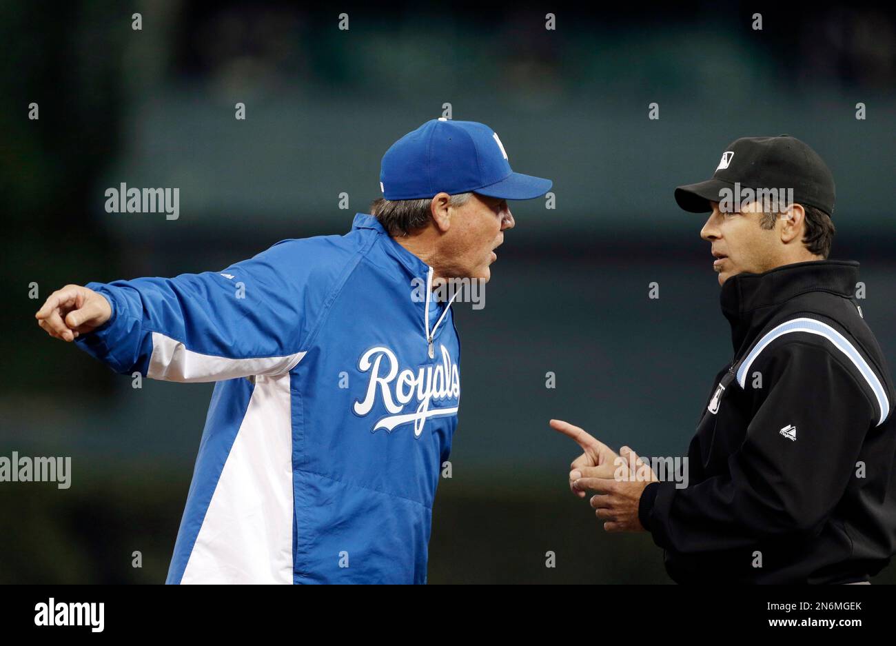 Kansas City Royals manager Ned Yost, left, argues the pick off at first ...