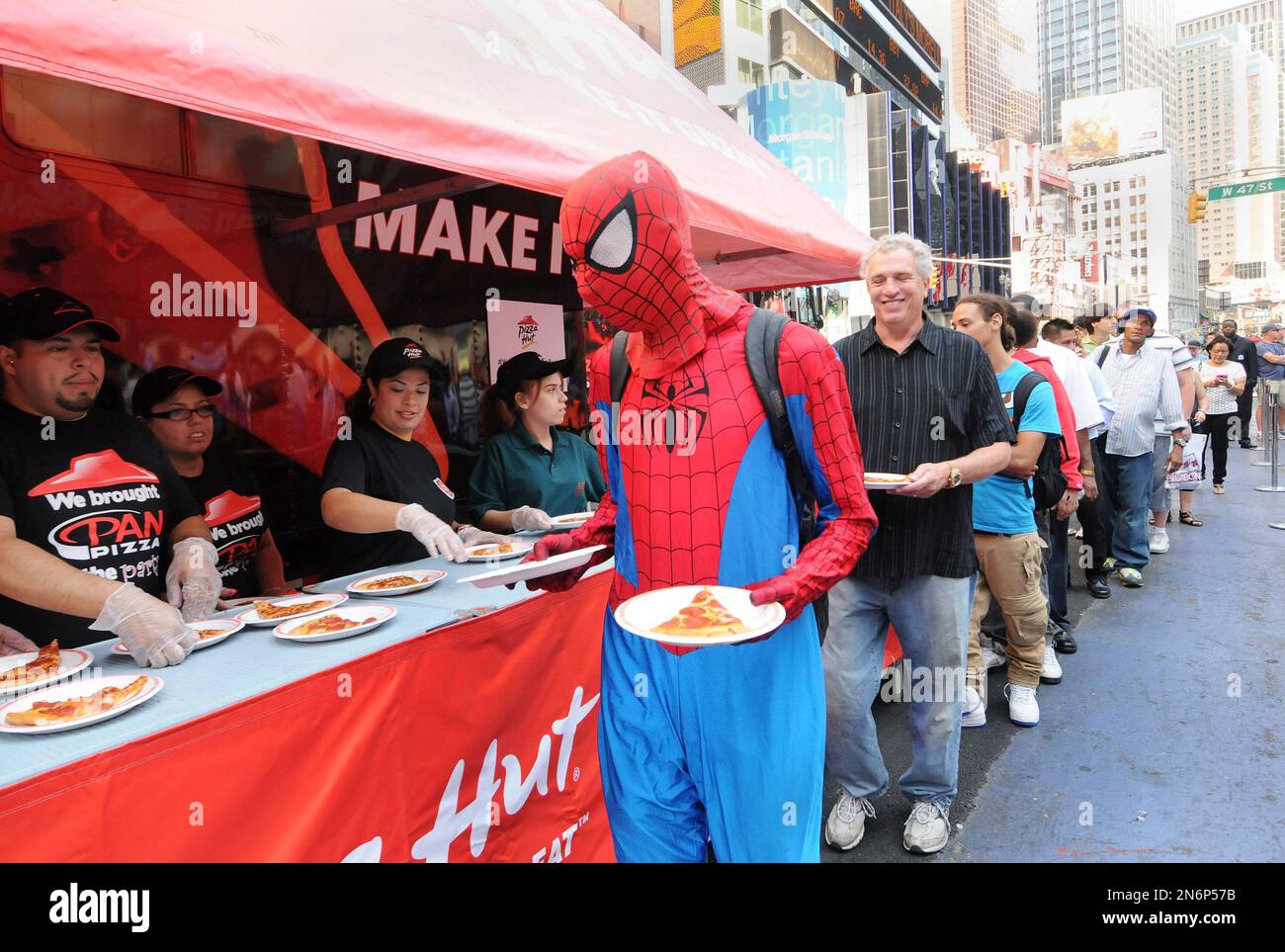 IMAGE DISTRIBUTED FOR PIZZA HUT - A costumed character leads a line of ...