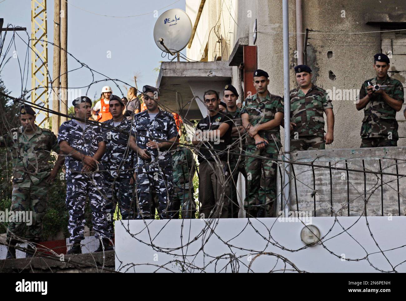 Lebanese police officers and army soldiers stand guard at their outpost ...