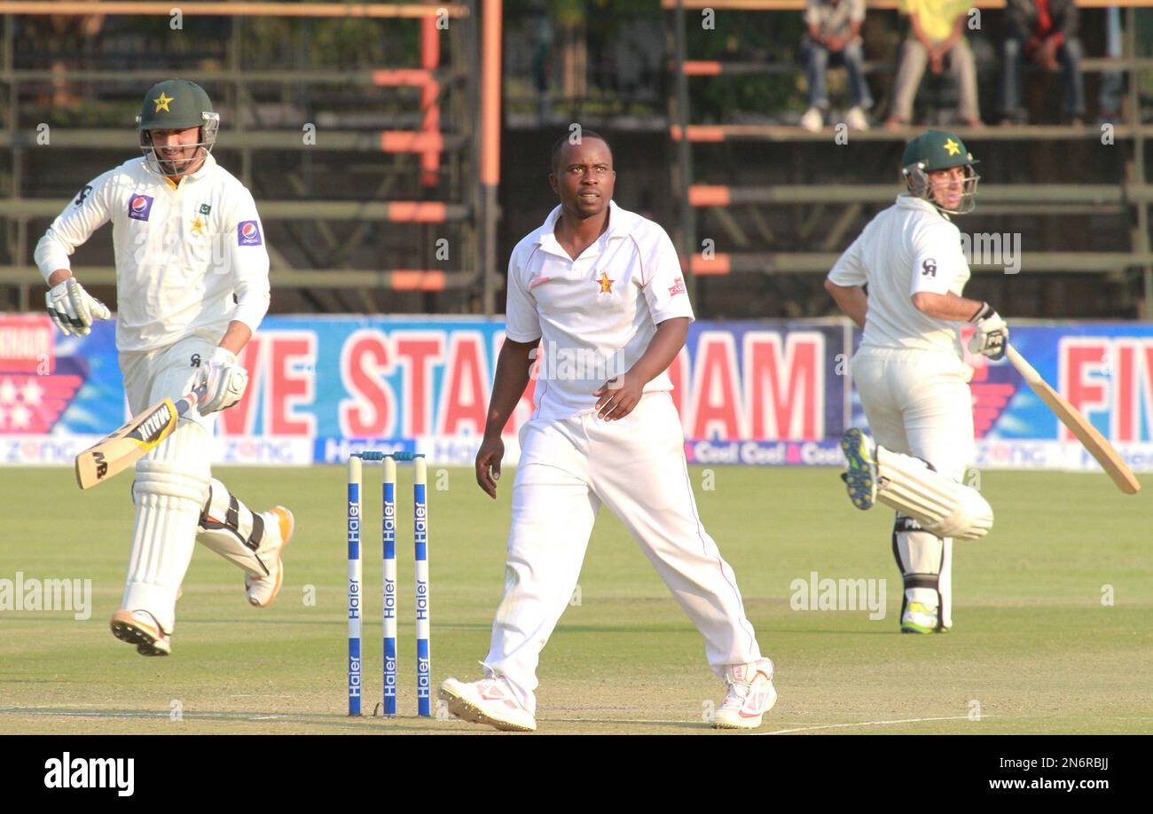 Zimbabwean bowler Prosper Utseya, centre, has his eyes on the ball as ...