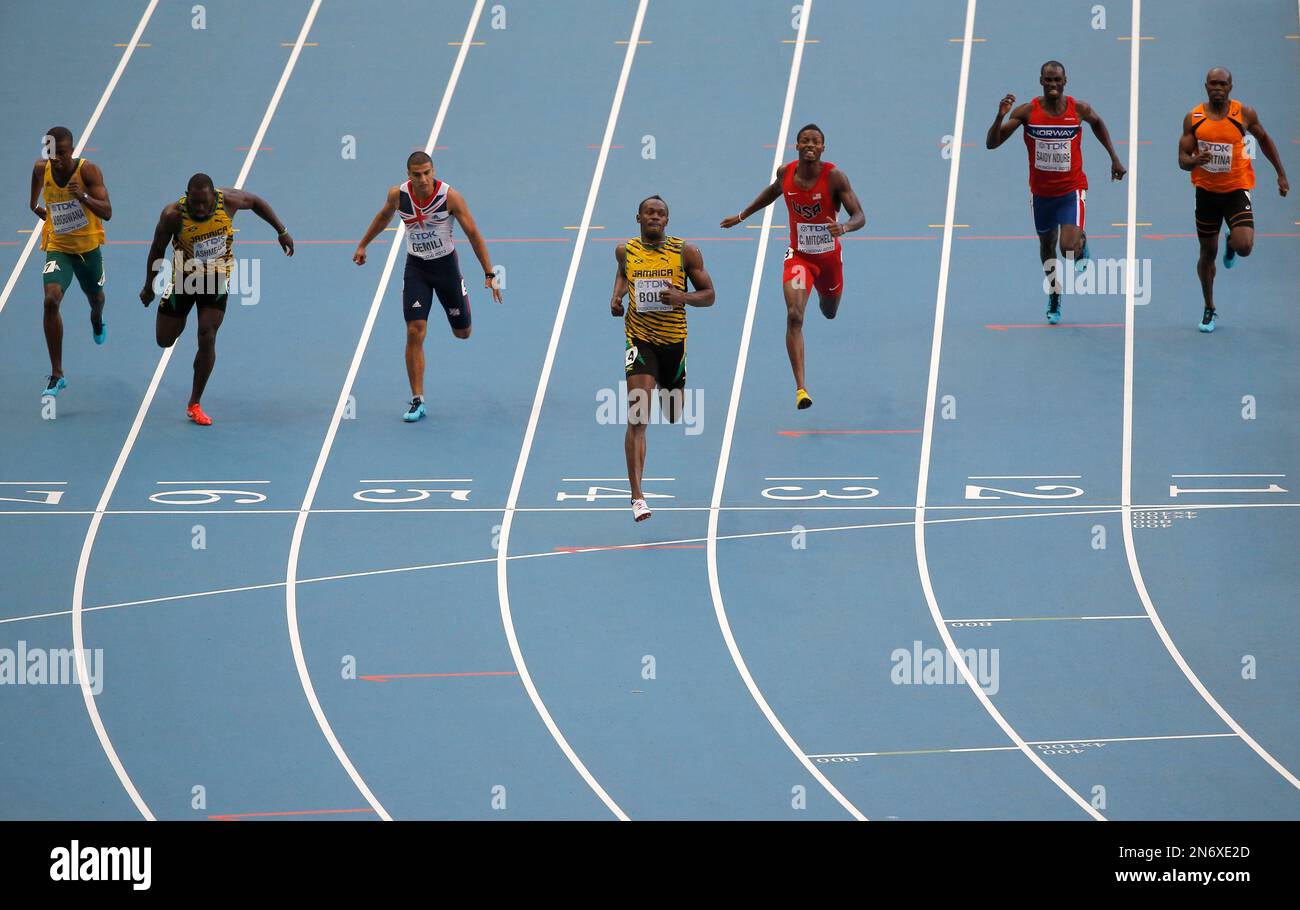 Jamaica's Usain Bolt, center, crosses the finish line to win the gold ...